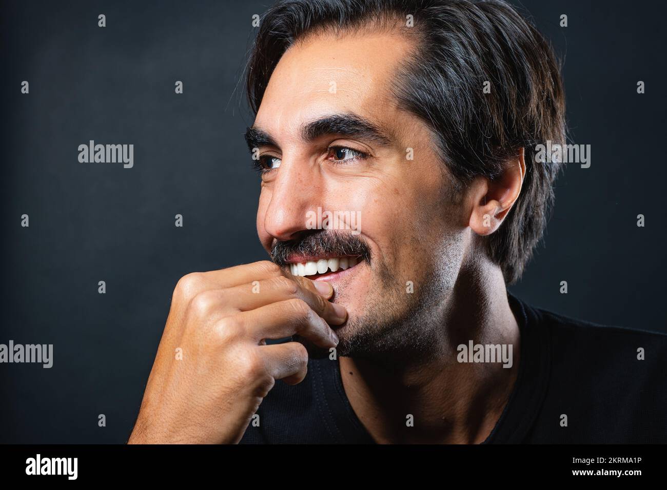 Crop positive male with dark hair and mustache having brown eyes ...