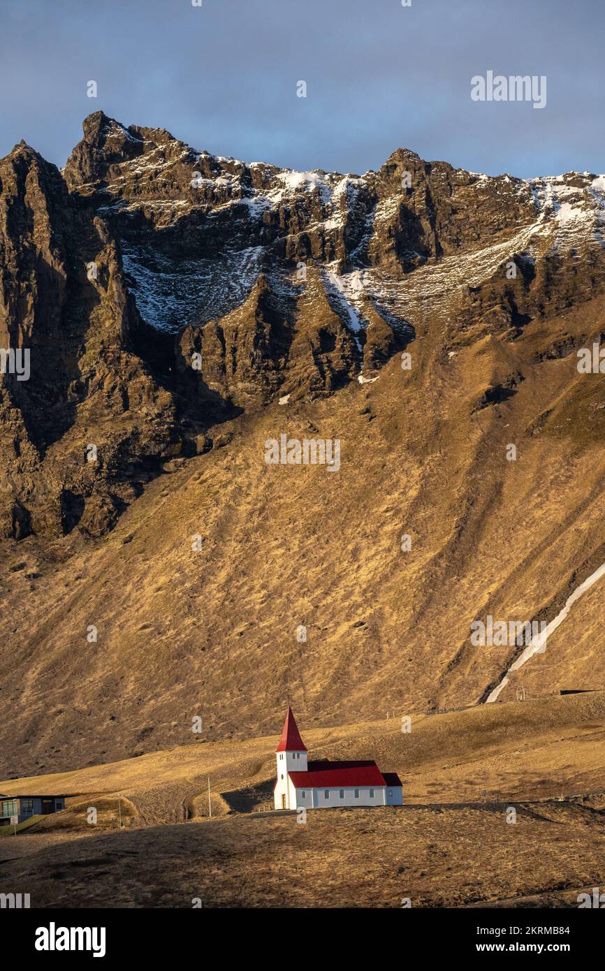 Reyniskyrka church located on grassy hill in countryside on sunny day ...