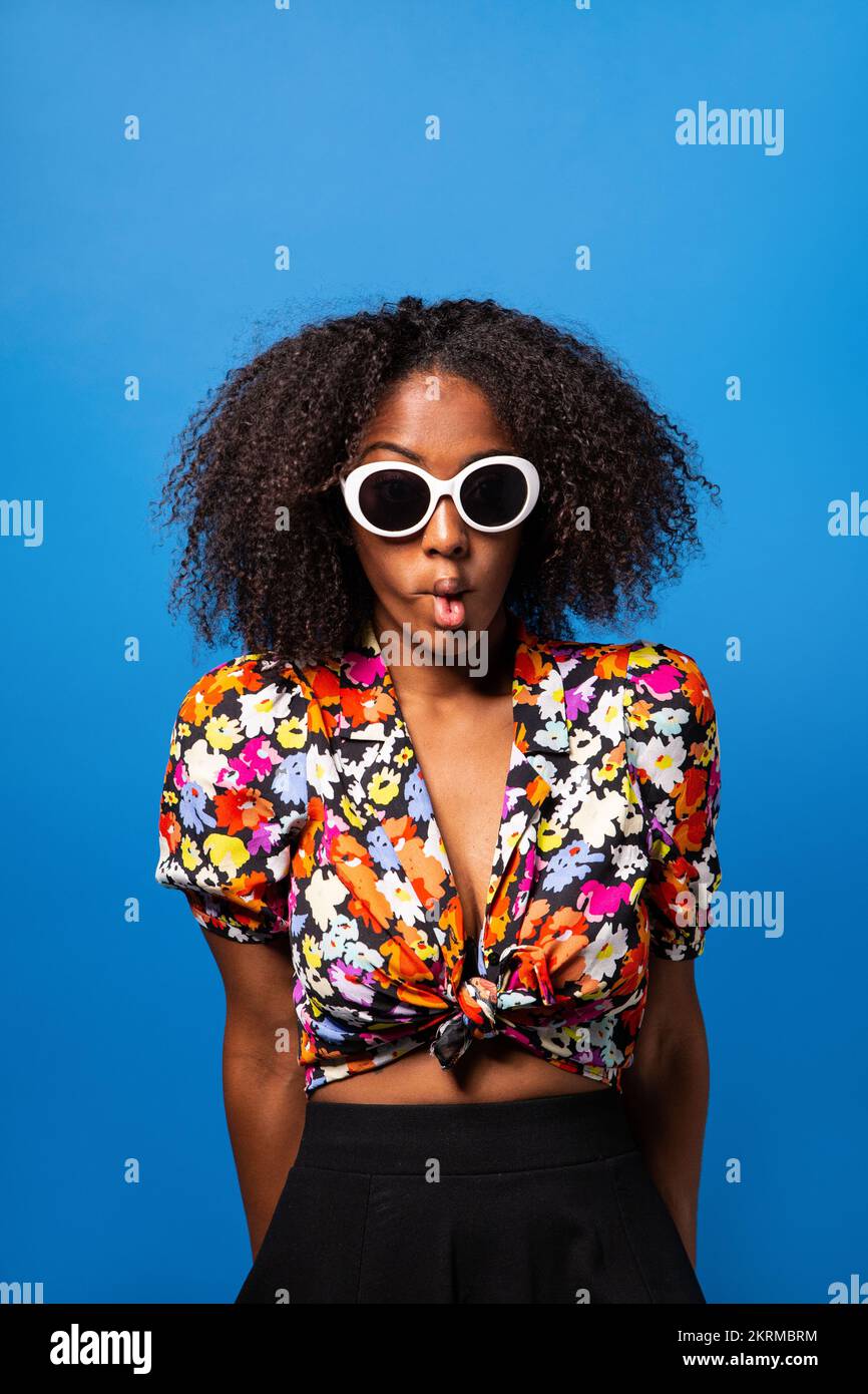 Young African American female in stylish clothes and sunglasses with ...