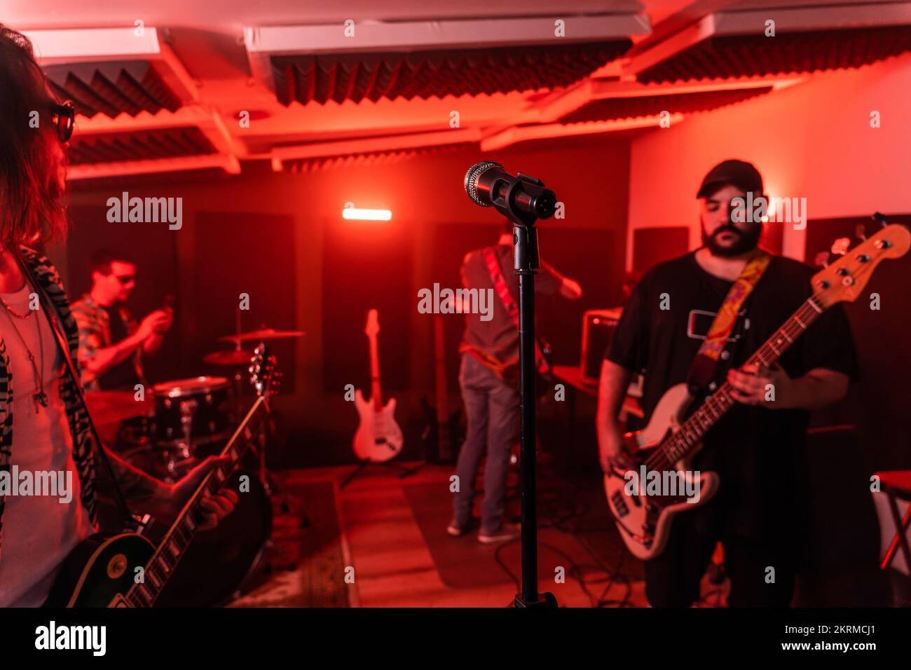 Microphone placed in studio during rehearsal of group of musicians ...