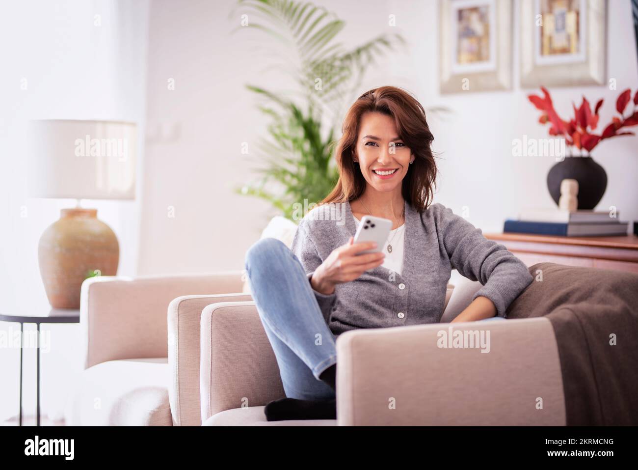 Attractive brunette haired woman wearing casual clothes while relaxing ...