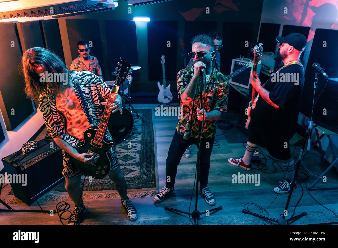 Group of musicians playing drums and guitars while vocalists singing ...