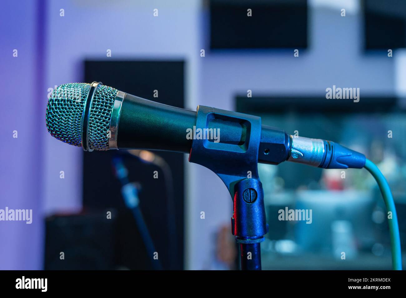 Professional mic with wire placed on counter in contemporary recording ...