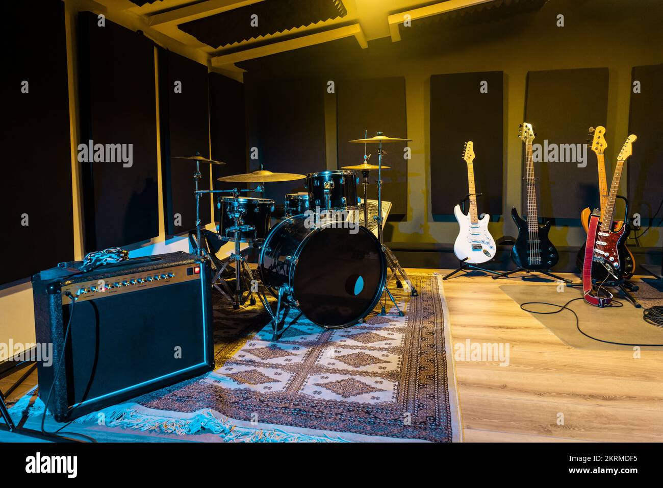 Contemporary music studio with electric and acoustic guitars placed on ...