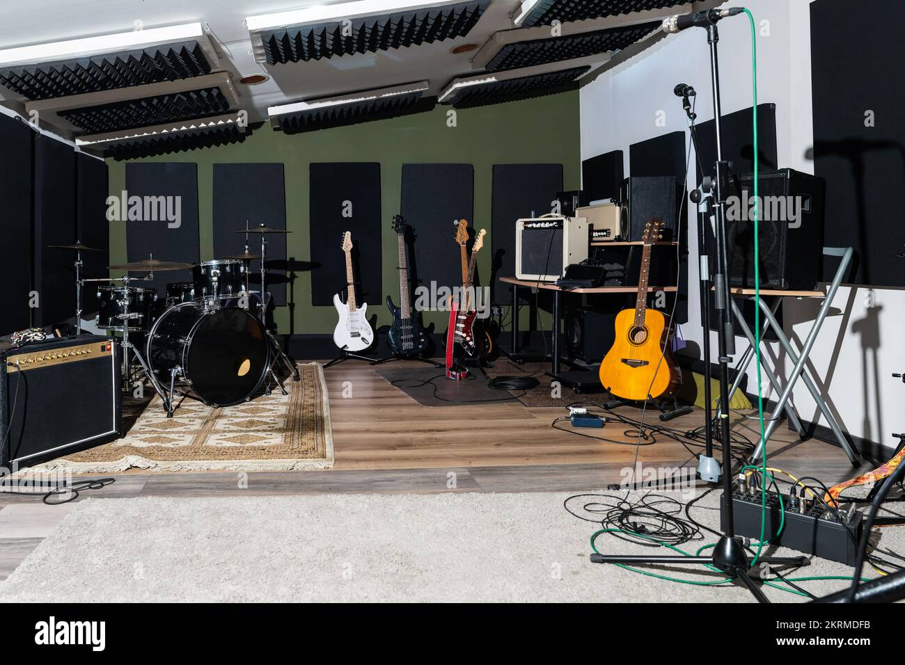 Contemporary music studio with electric and acoustic guitars placed on ...