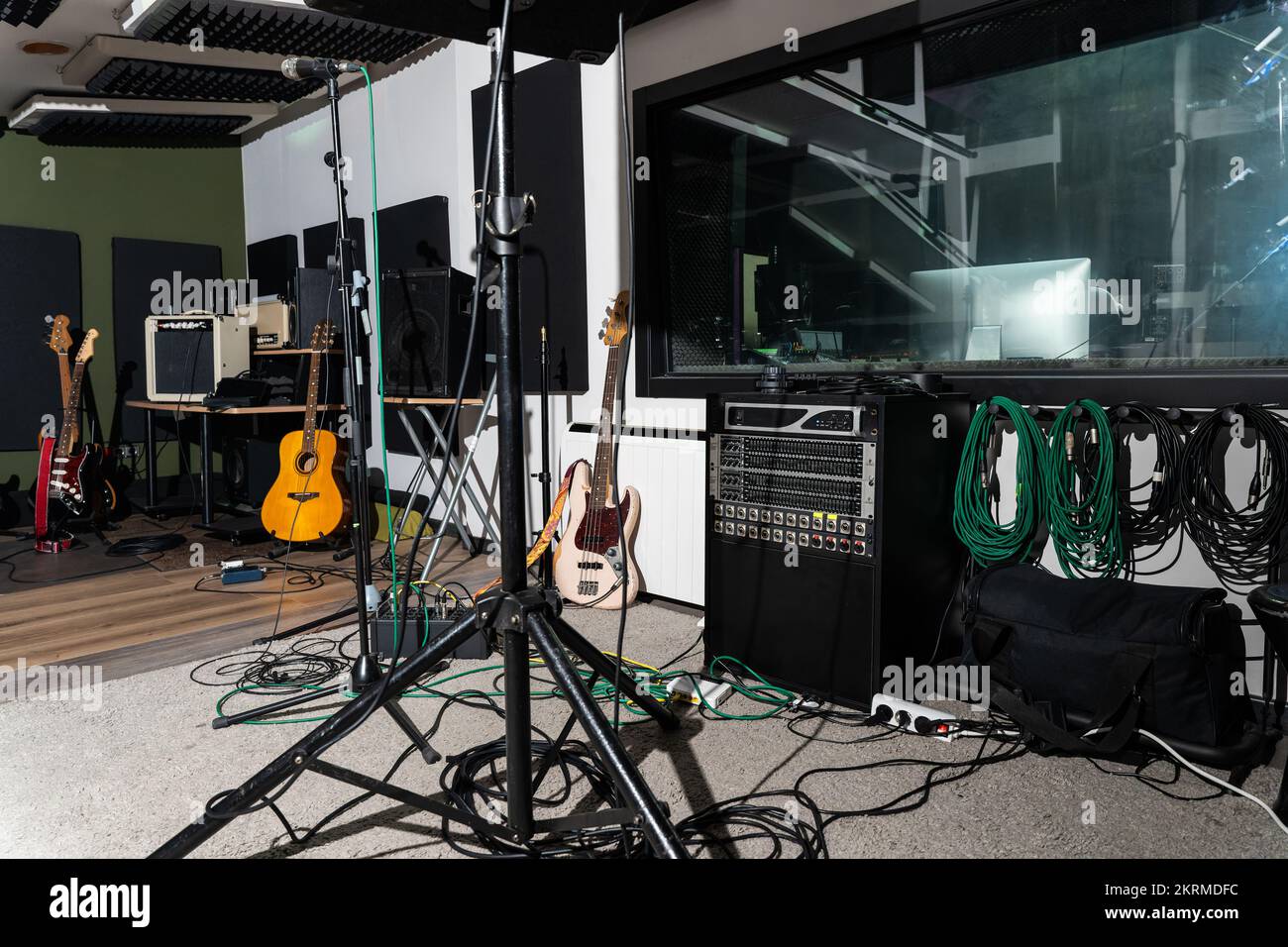 Contemporary music studio with electric and acoustic guitars placed on ...