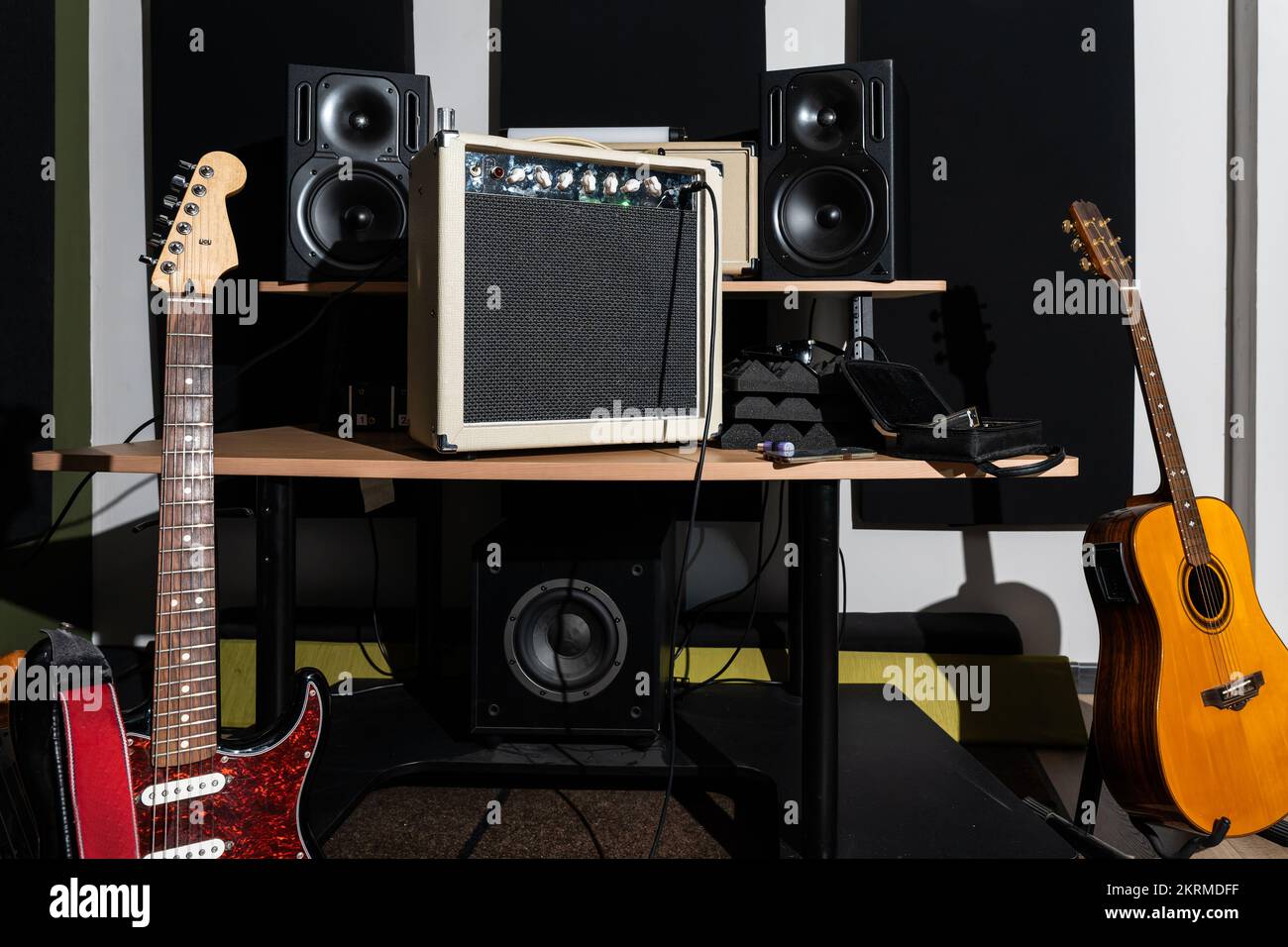 Contemporary music studio with electric and acoustic guitars placed on ...