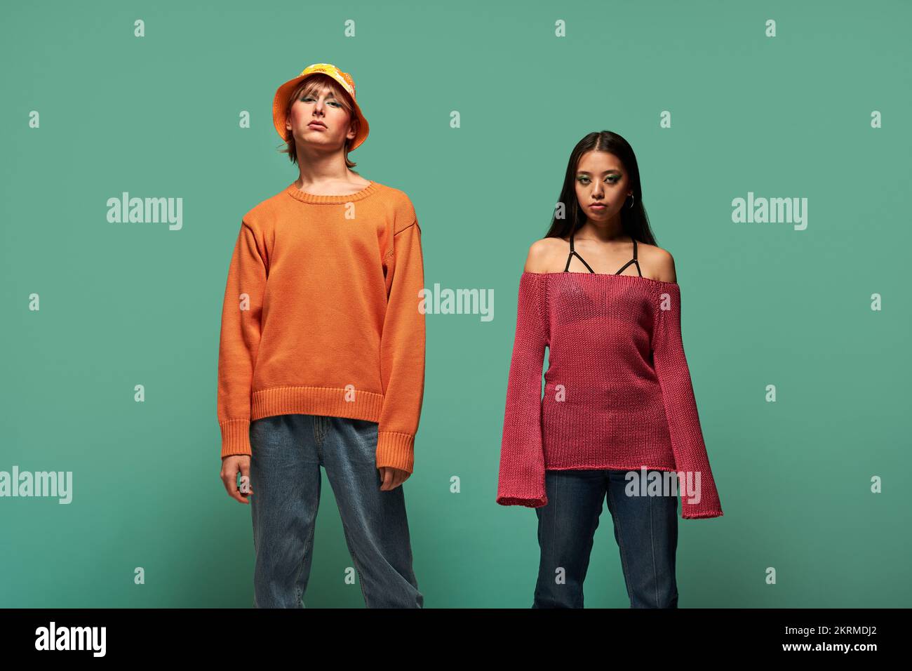 Diverse genderqueer models in colorful stylish clothes standing looking ...