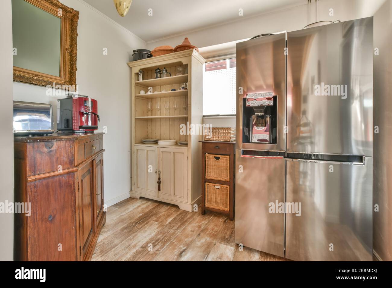 Wooden kitchen interior with large chrome fridge and vintage cabinet ...