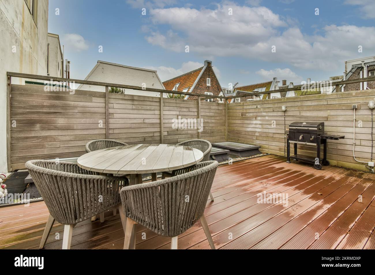 Terrace with table and chairs near bbq located in backyard cottage ...