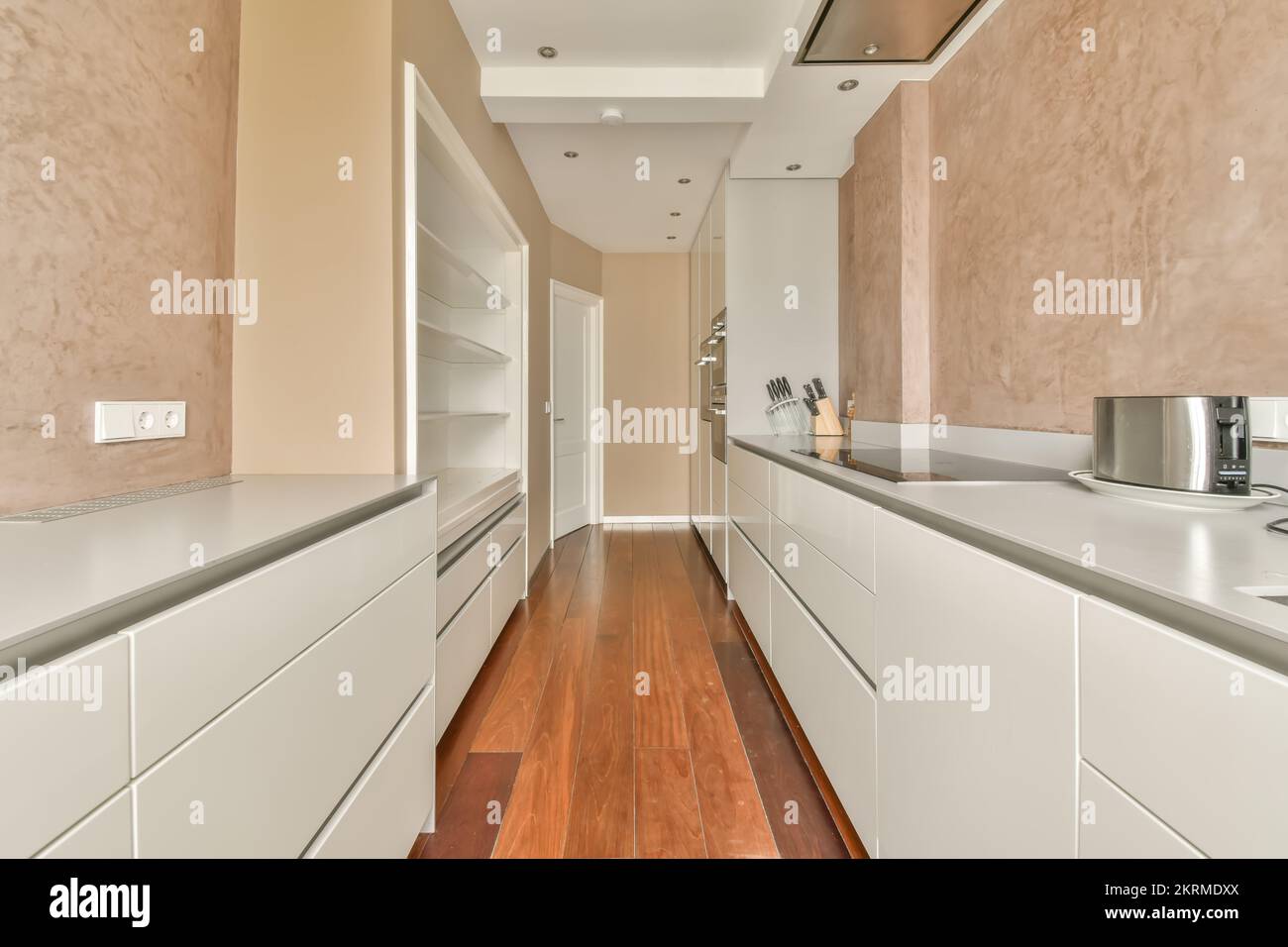 White counter with stove placed in stylish light kitchen with white ...