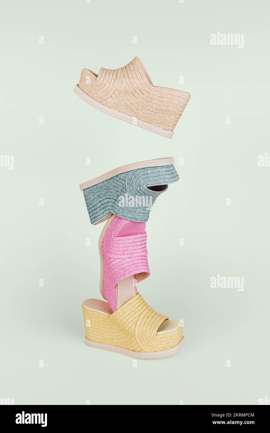Falling down colorful wicker wedge sandals with beige sole placed on ...