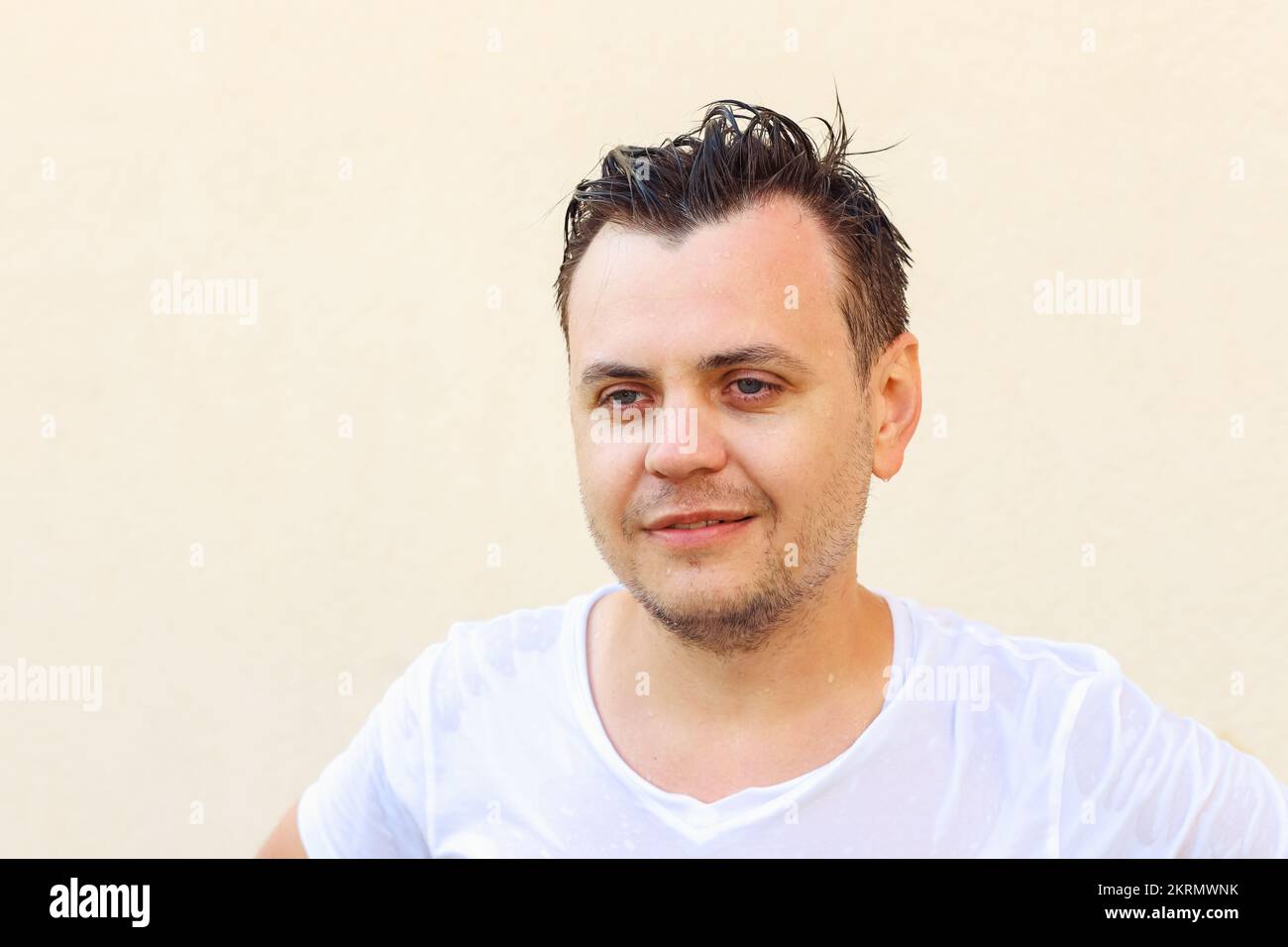 Wet european white young male man with water drops on his face after ...