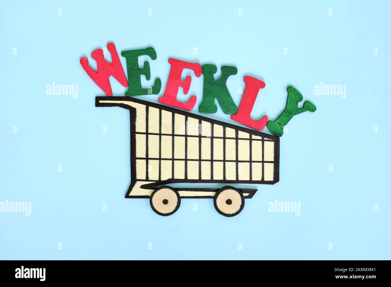 Weekly shopping schedule for grocery concept. Wooden shopping cart with ...