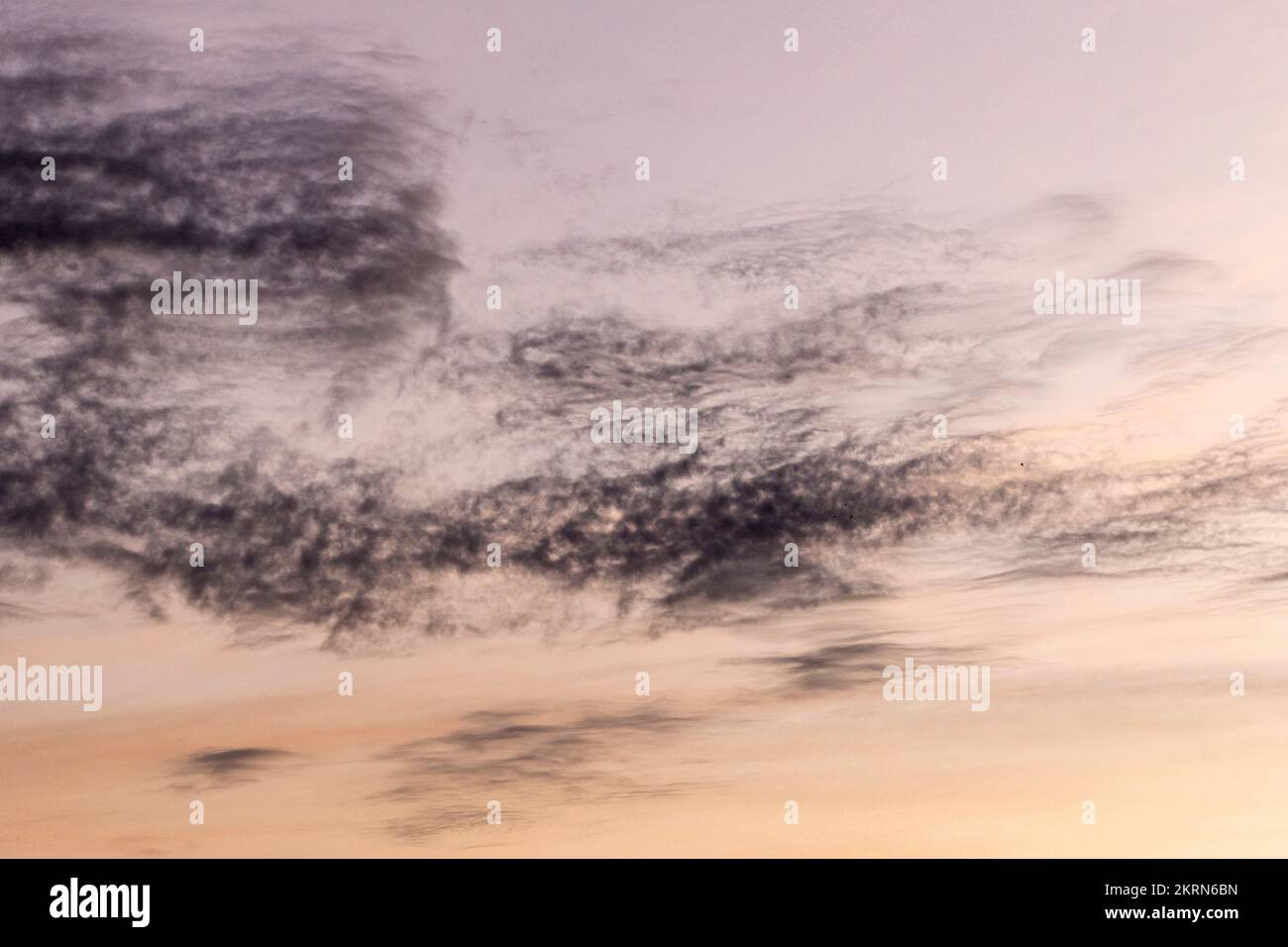 Ephemeral whisps of high-altitude Cirrocumulus clouds are highlighted ...
