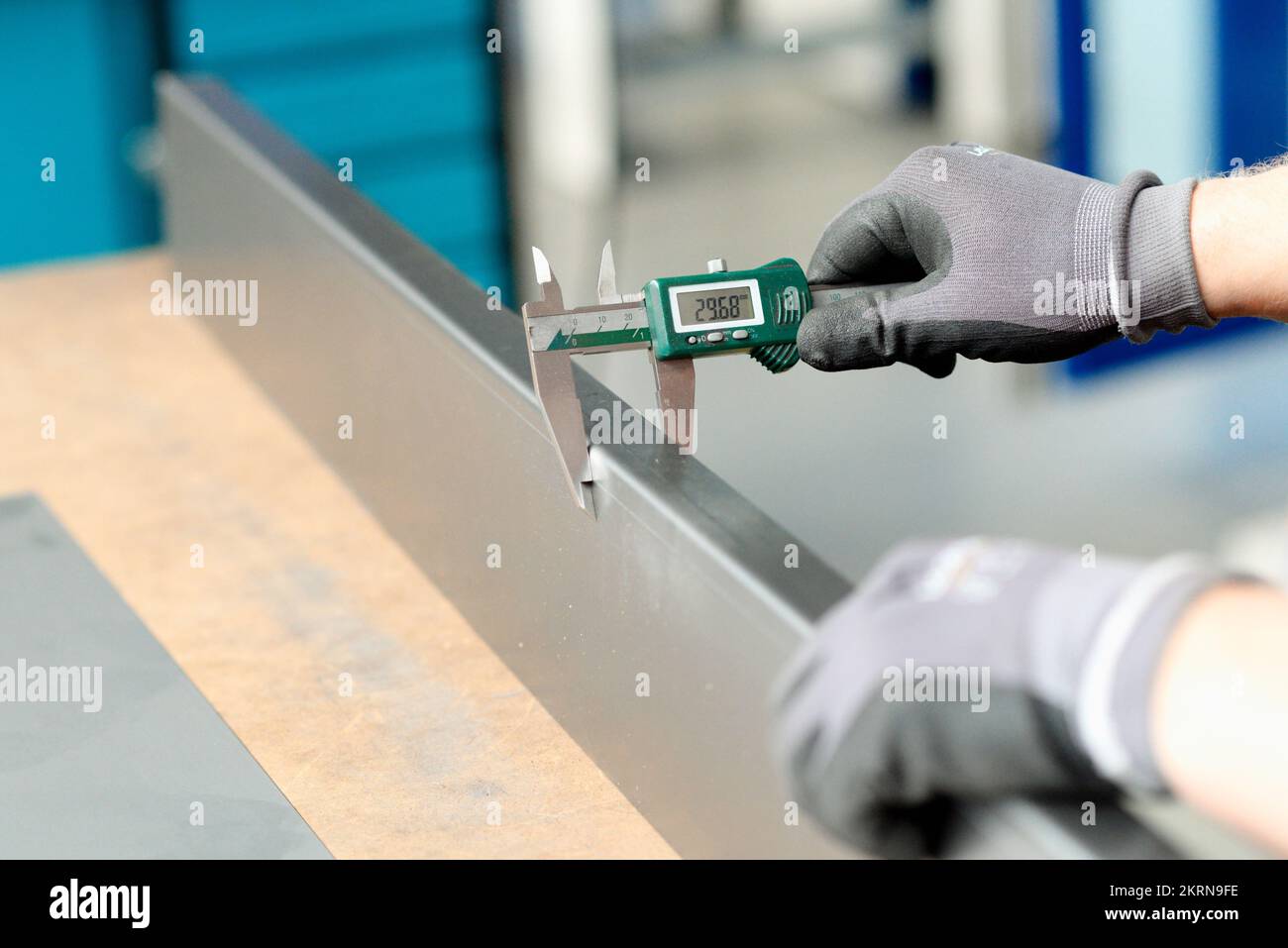 industrial workers inspect work piece for accuracy with measuring ...