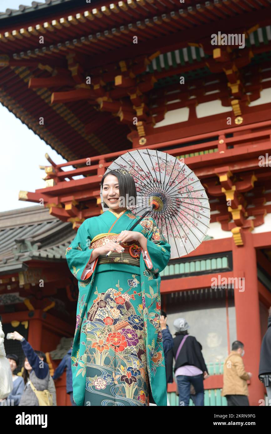 A young Japanese woman wearing a traditional Kimono and holding an Oil ...