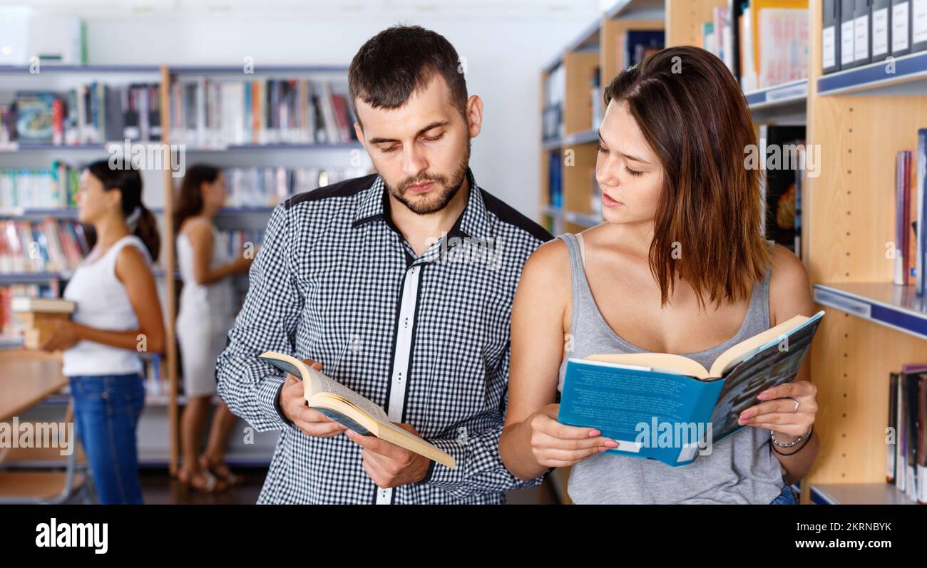 Young people spending time together, choosing and discussing books in ...