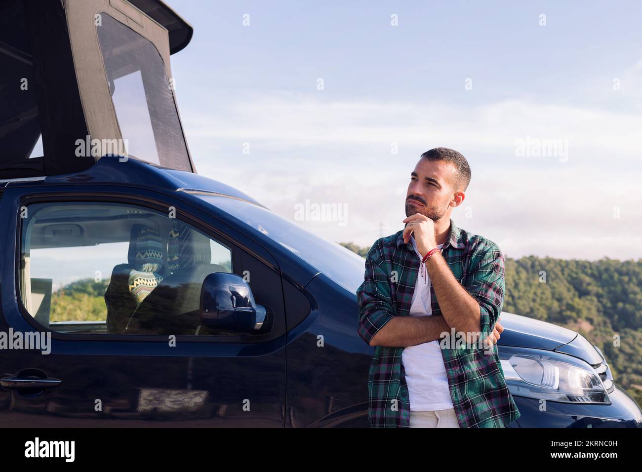 man leaning on his camper van observing nature Stock Photo - Alamy