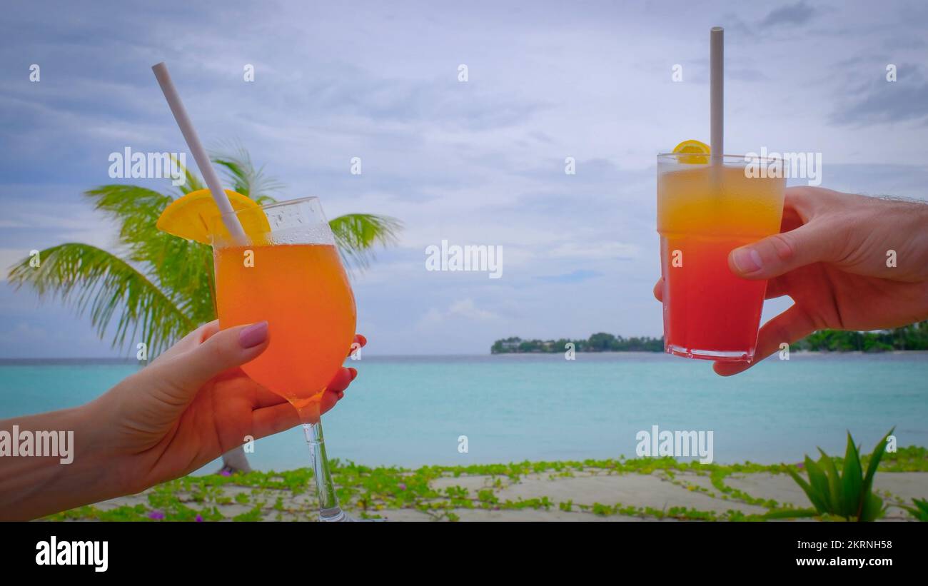 Close up of hands with cocktails making a toast Stock Photo - Alamy