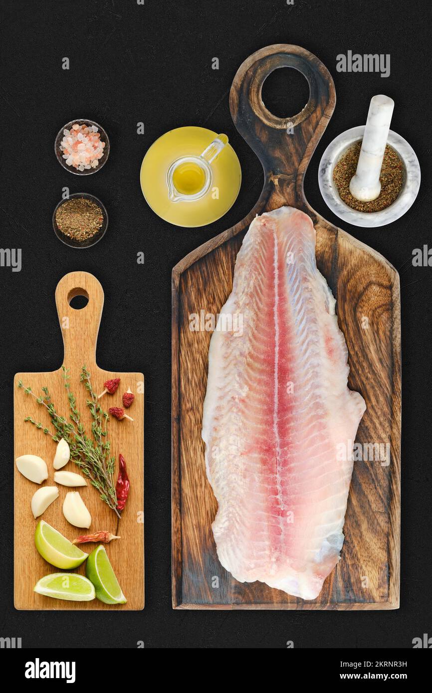 Fresh raw fillet of pangasius on black background Stock Photo - Alamy