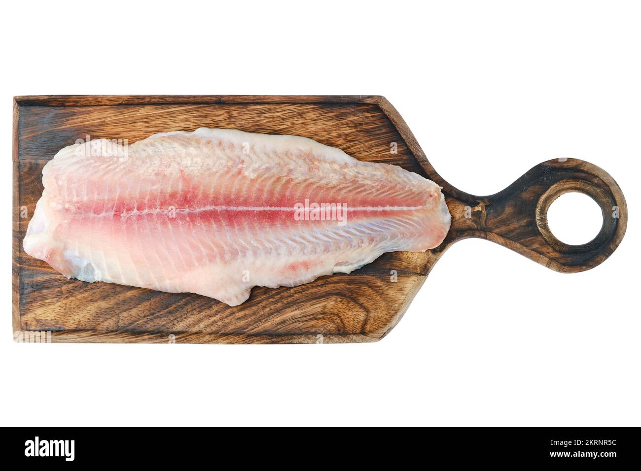 Top view of fresh raw fillet of pangasius on wooden cutting board ...