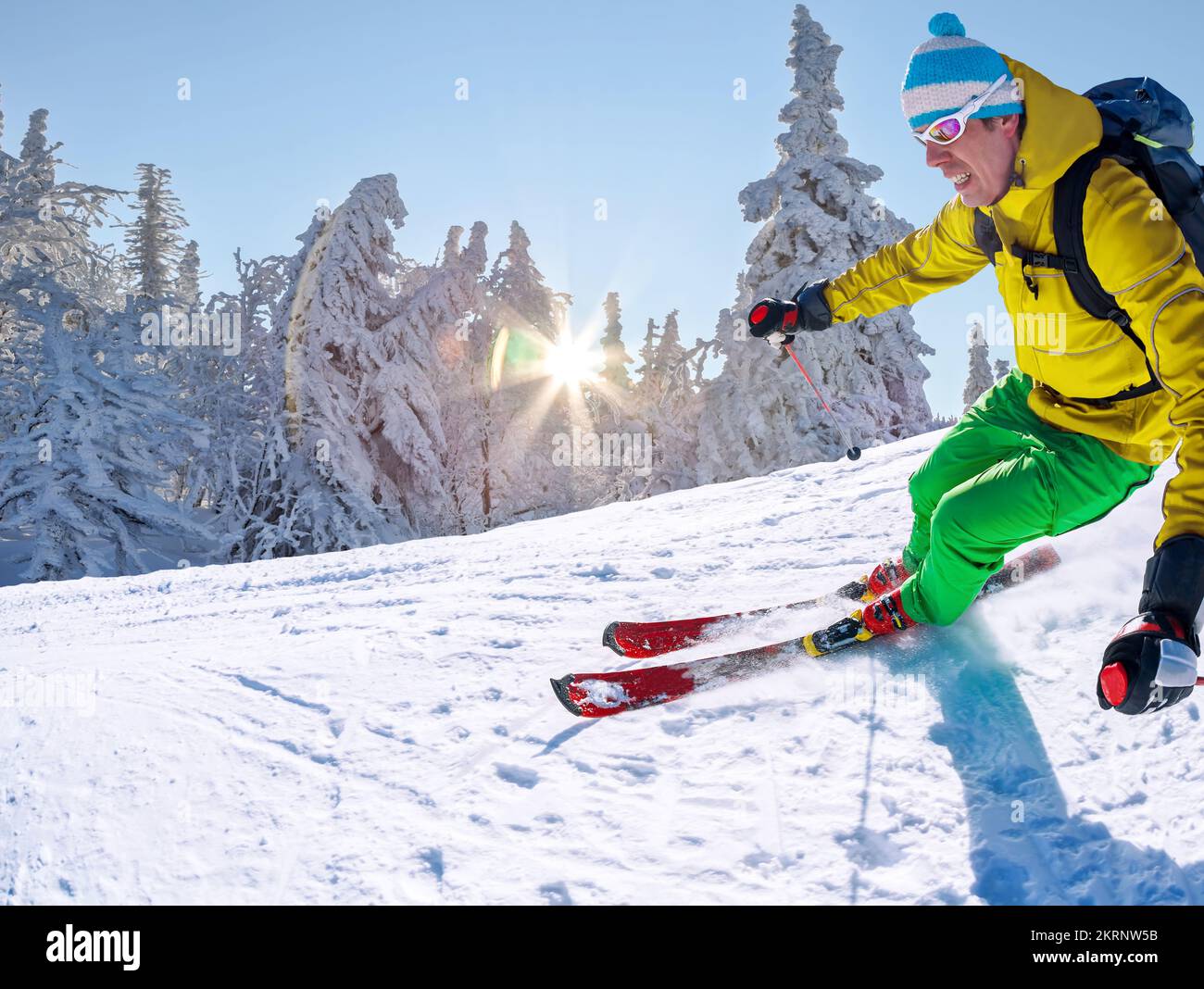 Skier skiing downhill in high mountains against against the fairytale ...