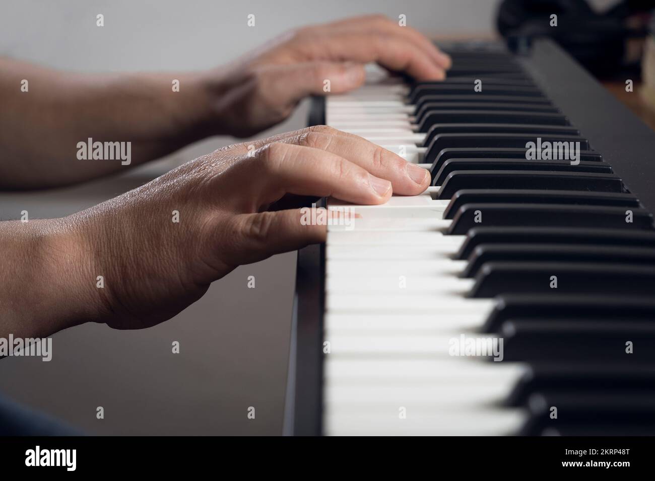 Detail of a man playing a midi keyboard Stock Photo - Alamy