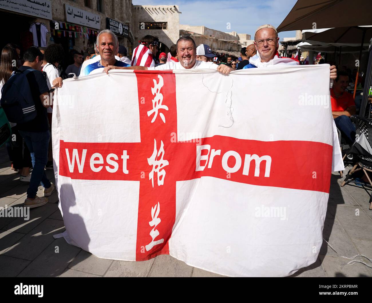 England fans pose for a photograph at the souq in Doha on the day of ...