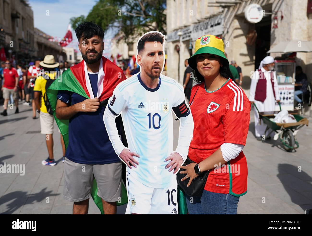 Fans pose for a photograph with a cardboard cut-out of Argentina's ...