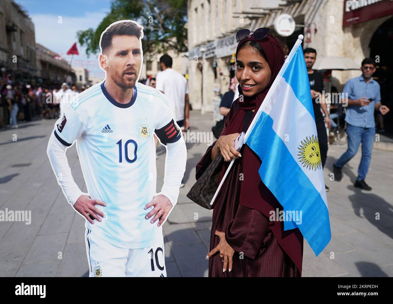 A fan poses for a photograph with a cardboard cut-out of Argentina's ...