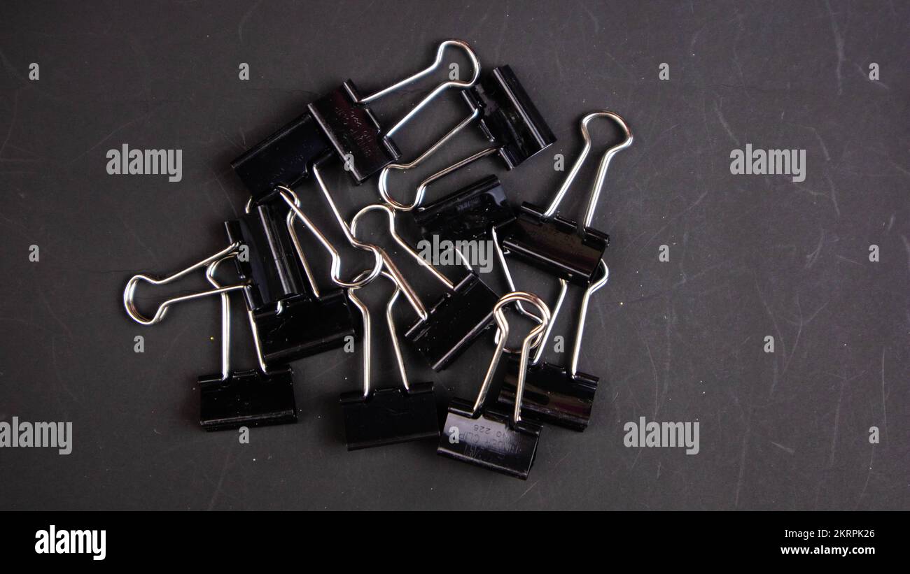 black paper clip on black background Stock Photo - Alamy