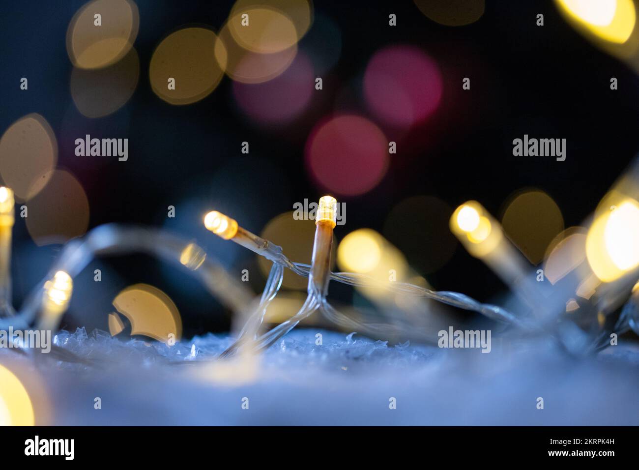 christmas string lights in snow Stock Photo - Alamy