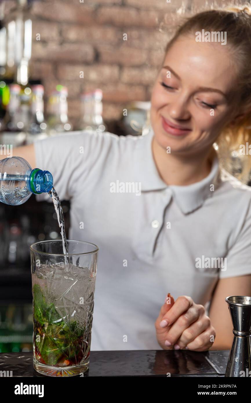 Smiling bartender making alcoholic cocktails hi-res stock photography and images - Alamy