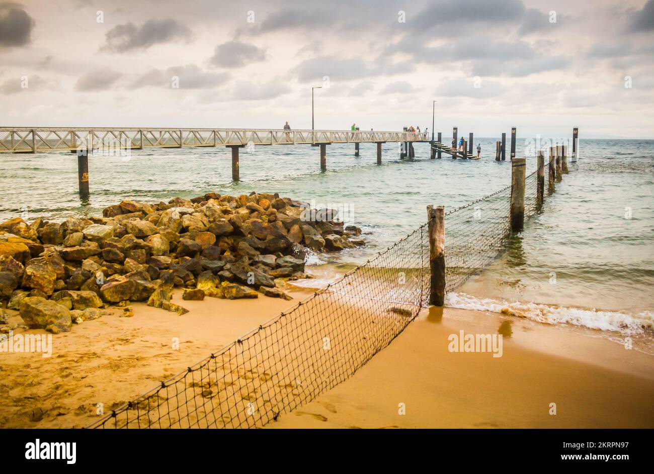 Late afternoon seaside landscape on a beach jetty with fishing ...
