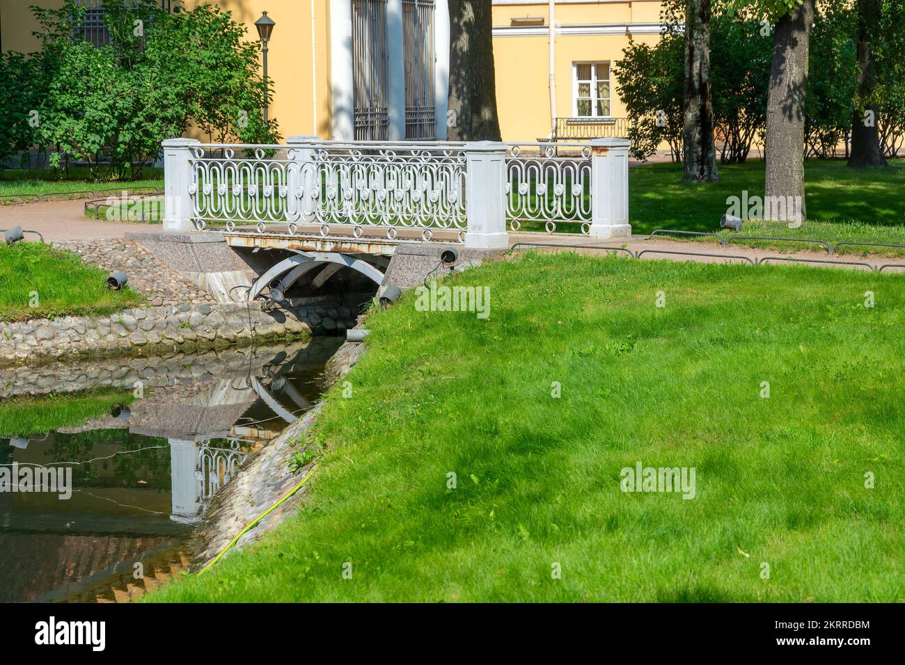 Decorative pedestrian bridge over a small canal in the park Stock Photo ...