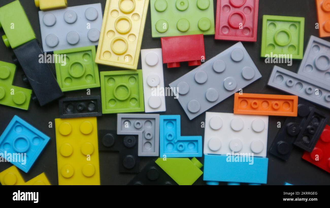 Plastic toy blocks on black background Stock Photo - Alamy