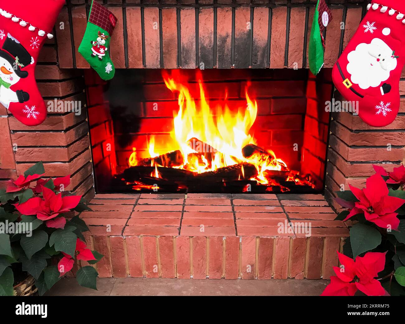 A fake fireplace is a Christmas decoration. Christmas socks, poinsettia ...