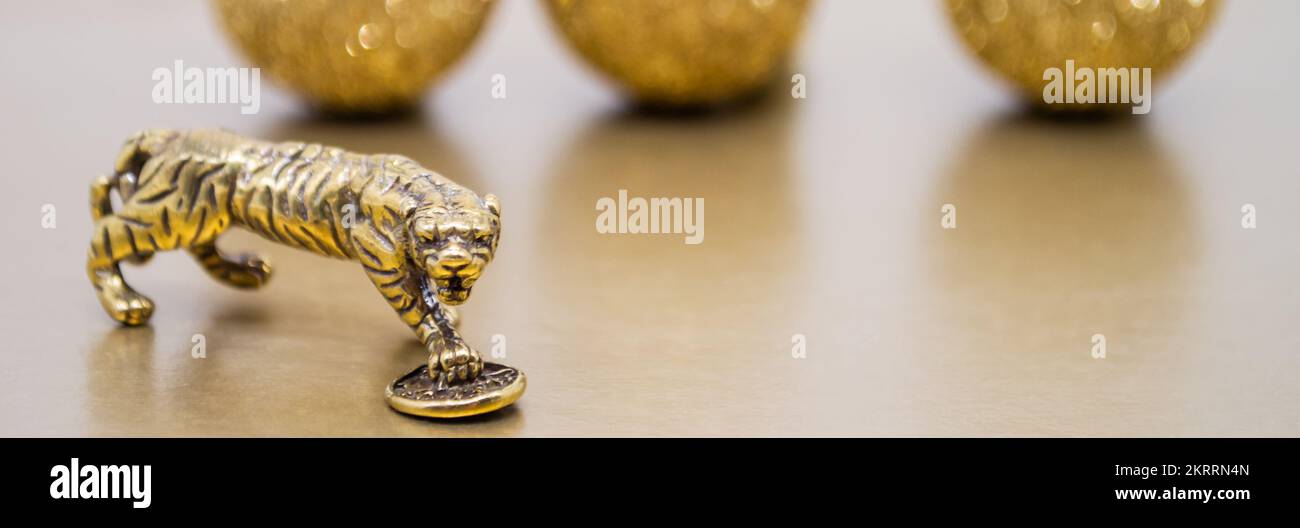 Banner with bronze figure of a tiger with a coin on a background with ...
