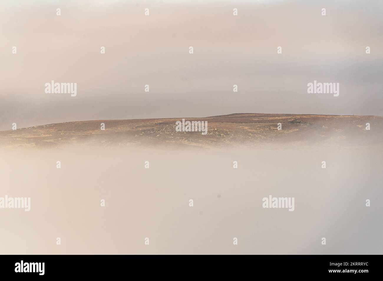 A hilltop emerges from thick fog in Northumberland, UK Stock Photo - Alamy