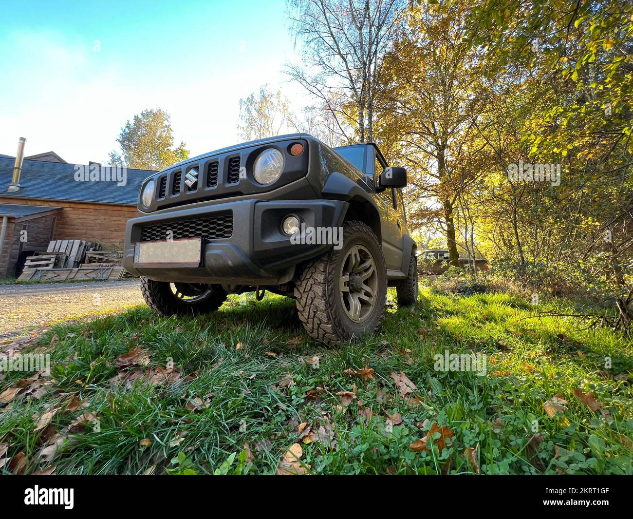Low and wide angle shot on a small grey colored Suzuki Jimny Jeep in ...