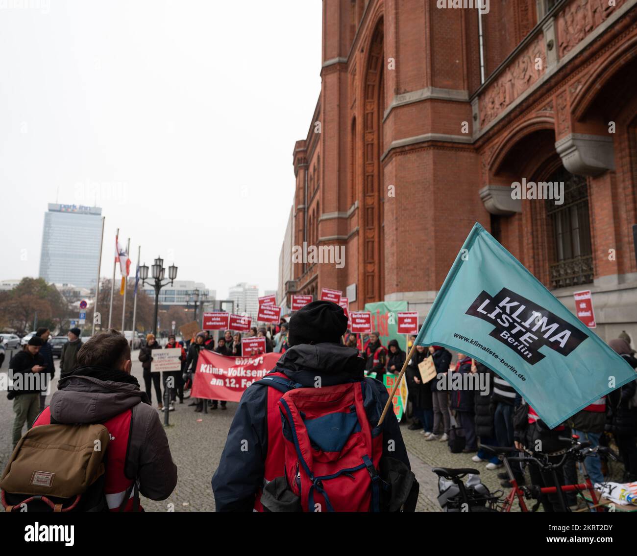 Berlin, Germany. 29th Nov, 2022. A man stands next to demonstrators ...