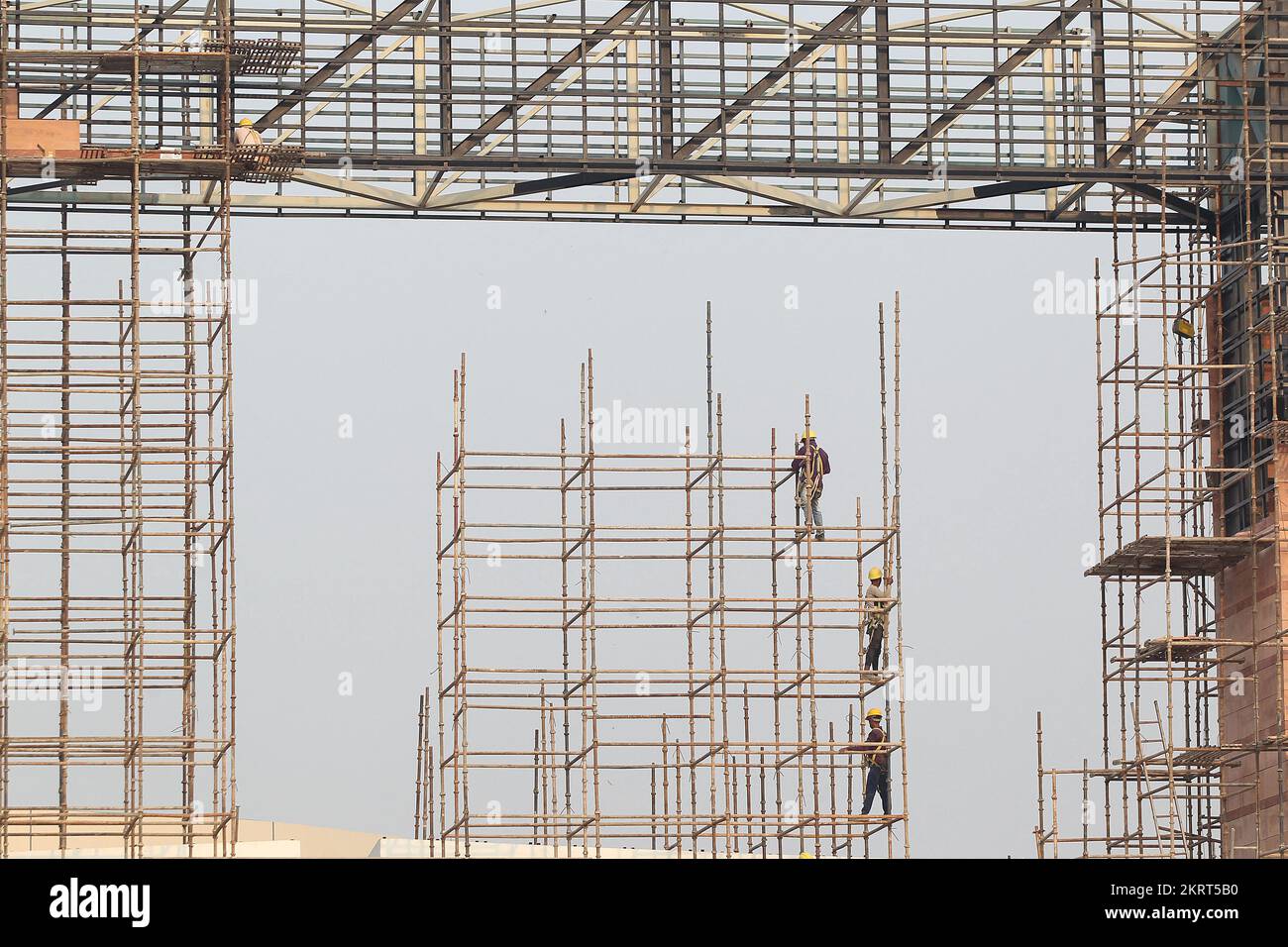 Labourers work at an under construction site near Pragati Maidan in New ...