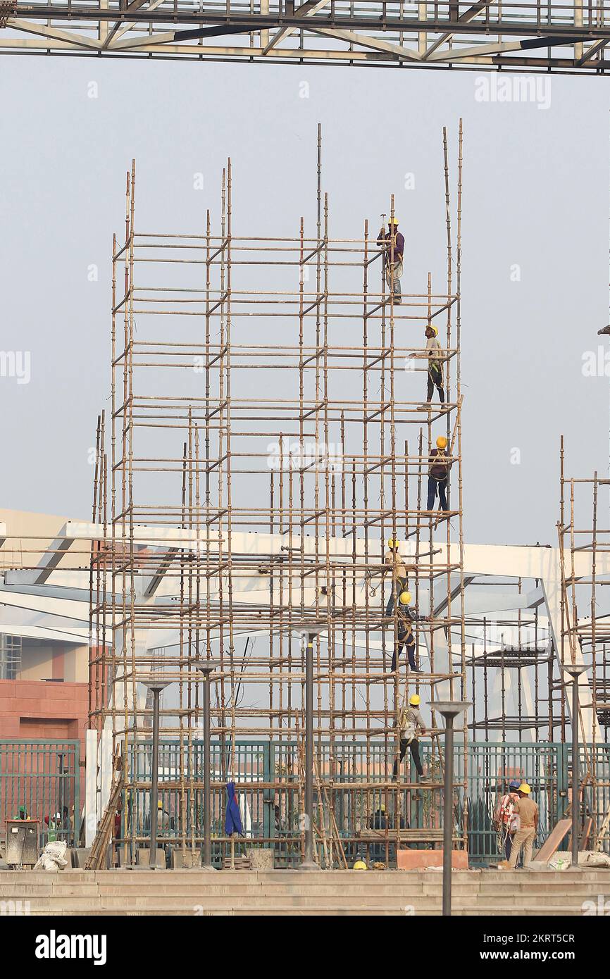 Labourers work at an under construction site near Pragati Maidan in New ...