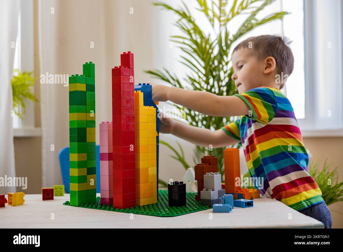 Child smiling building blocks tower hi-res stock photography and images ...