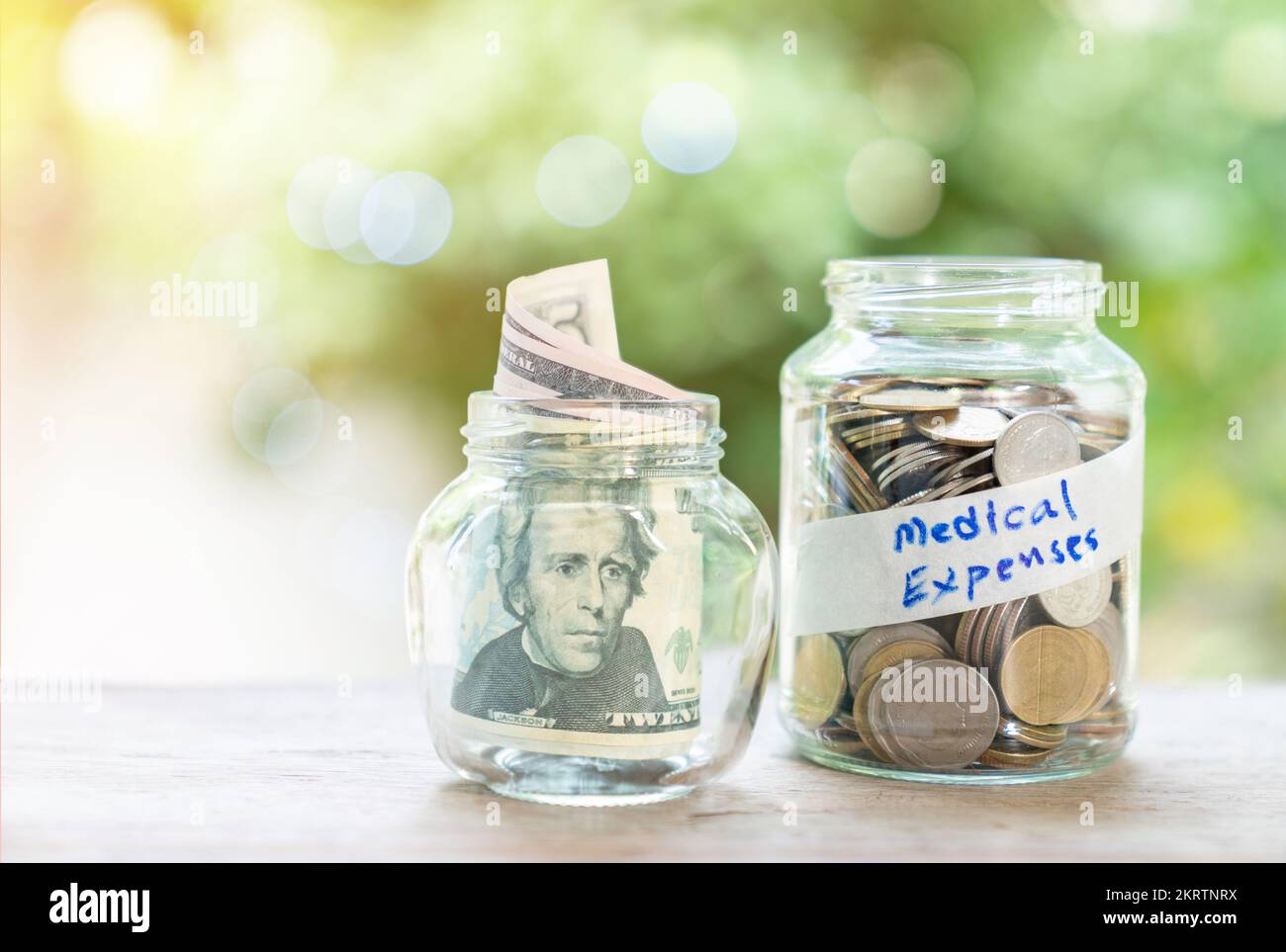 Coins adn dollar billsin glass jar with medical expenses label ...