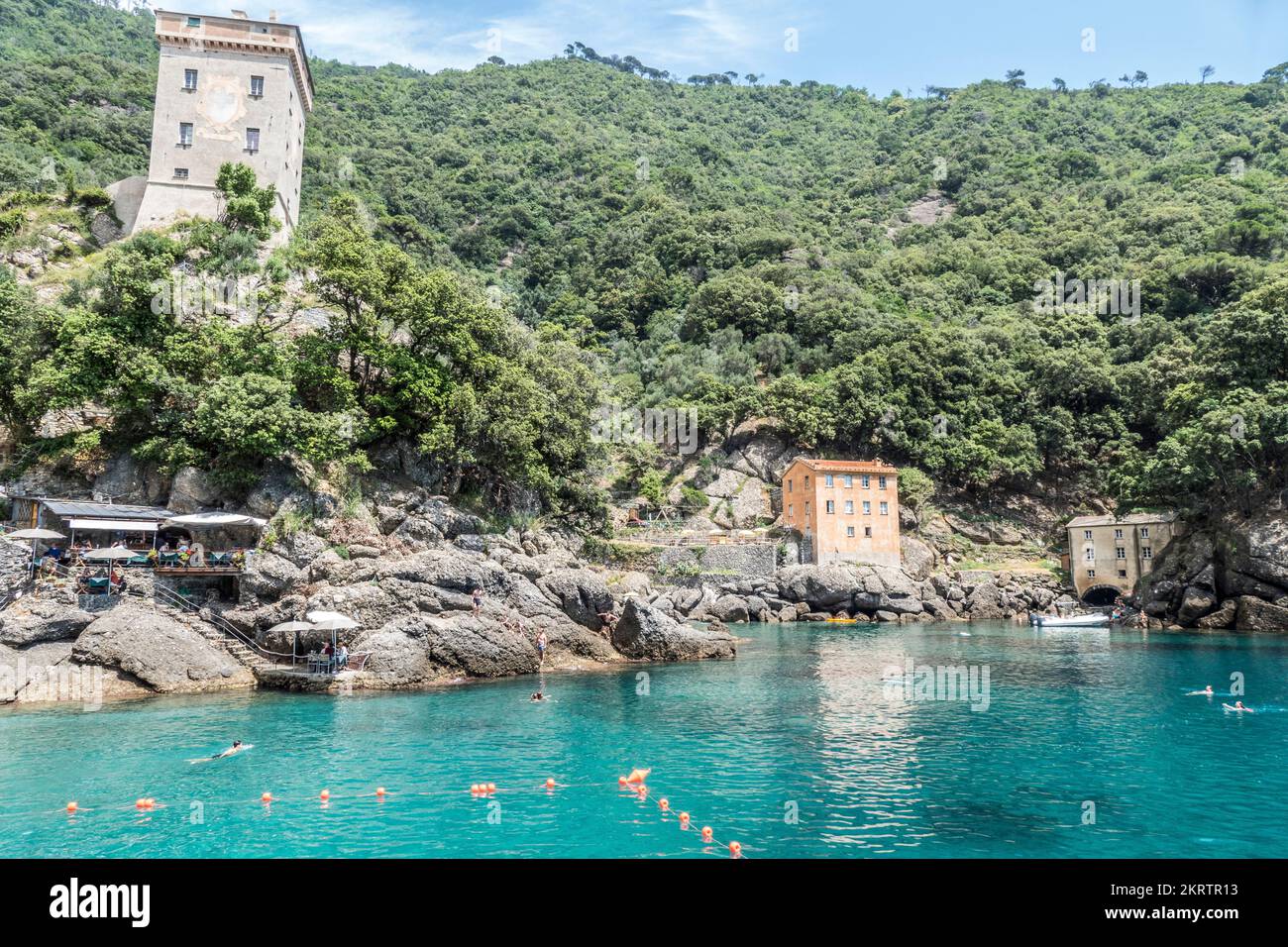 The bay of San Fruttuoso with green water and the abbey near the beach ...