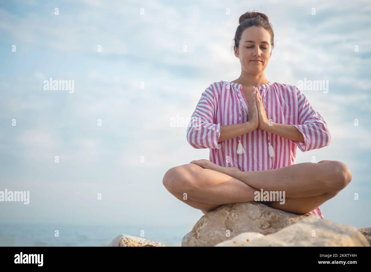 Happy relaxed woman meditation in lotus position practicing yoga ...