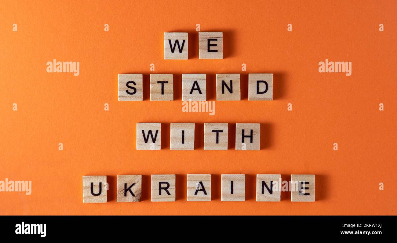 We stand with Ukraine word phrase in wooden letters. Motivation and ...
