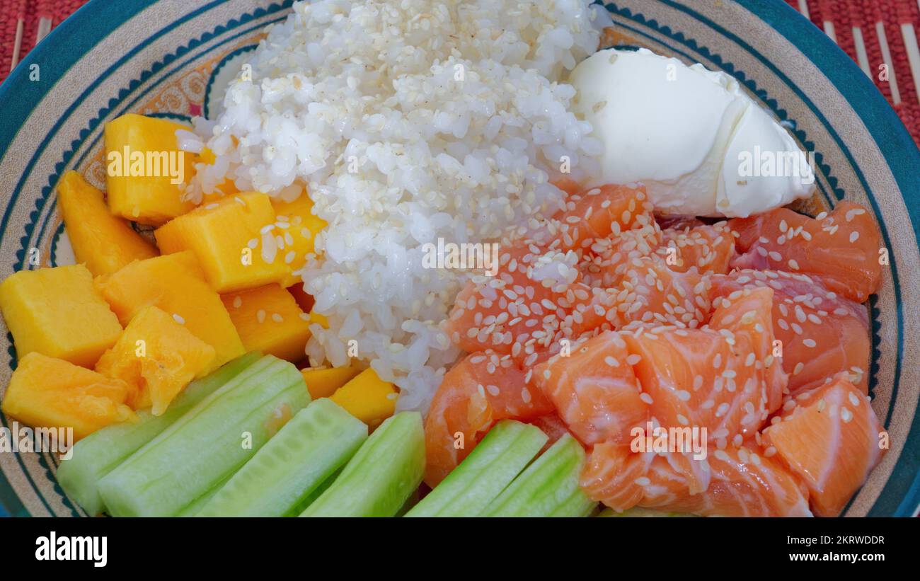 Delicious poke bowl with salmon and vegetables close up Stock Photo - Alamy
